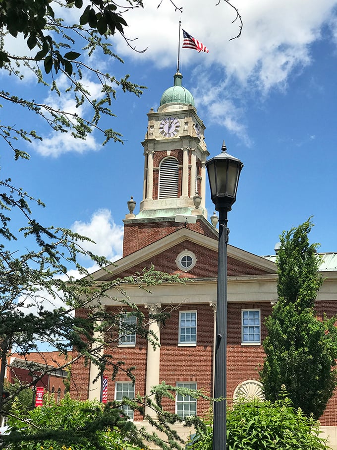 The Warren County Courthouse rises proudly with its distinctive clock tower and American flag, a brick-and-mortar testament to small-town governance.