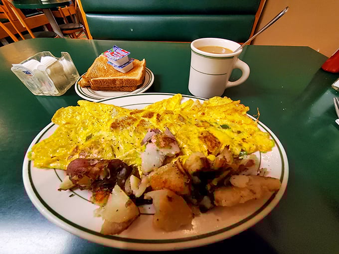 An omelet that's seen things—namely cheese, potatoes, and enough fillings to make each bite a treasure hunt of breakfast flavors. Coffee mandatory.