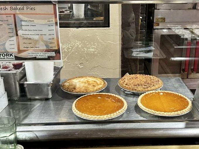 Homemade pies lined up like edible artwork—choosing just one slice becomes the most delicious dilemma of your day.