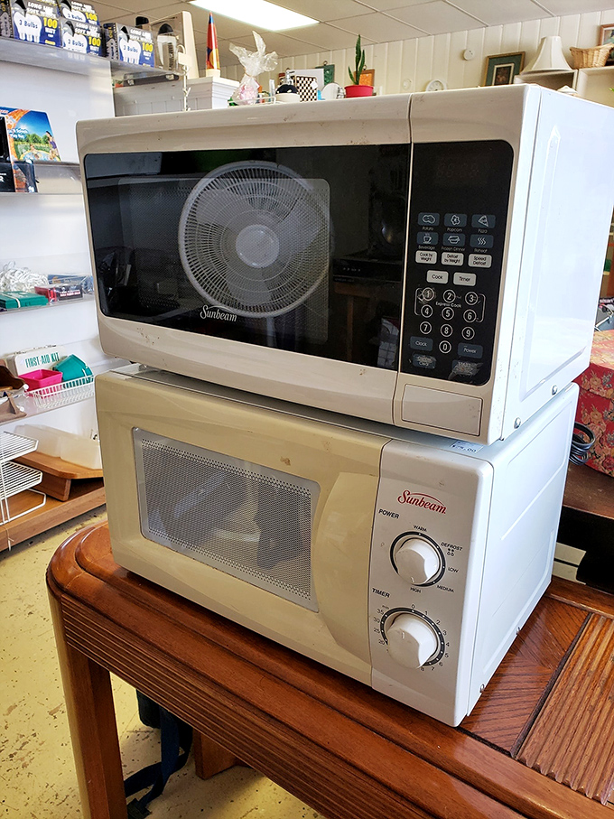 Sunbeam microwaves stacked like technological time capsules. They don't make 'em like they used to—and sometimes that's exactly what you want.