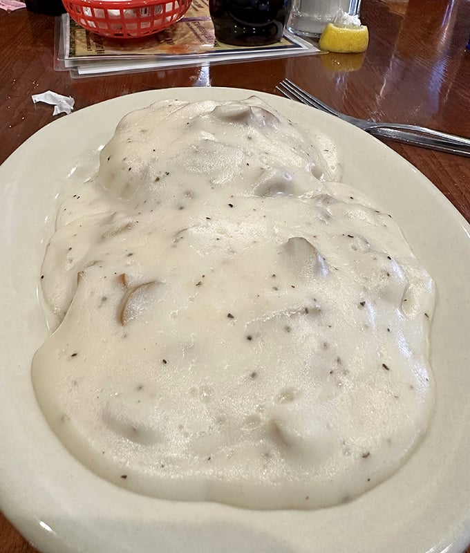 What looks like a cloud but tastes like heaven? This plate of biscuits smothered in creamy gravy – the ultimate Southern comfort.
