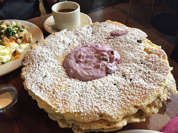 This stack isn't just a pancake—it's a purple-crowned monument to morning indulgence. That cream center is the breakfast equivalent of finding an extra $20 in your pocket.