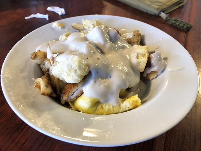 The breakfast bowl—where gravy cascades over potatoes and eggs like a morning waterfall of comfort. Spoon or fork? Yes.