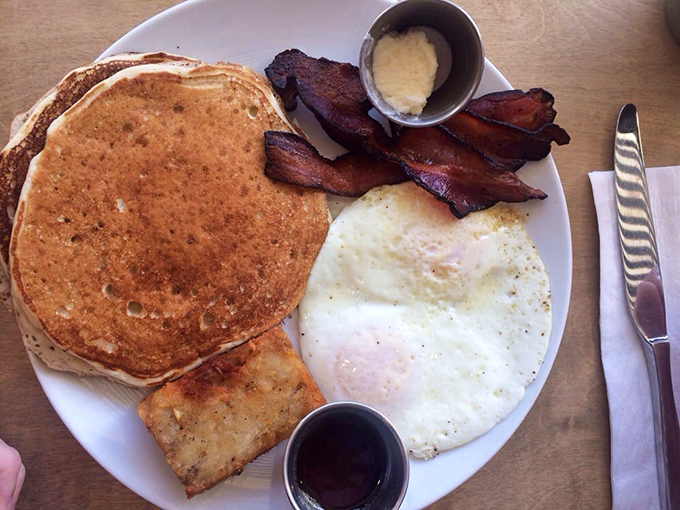 The classic breakfast plate—pancakes, eggs, bacon—executed with such perfection it reminds you why classics became classics.