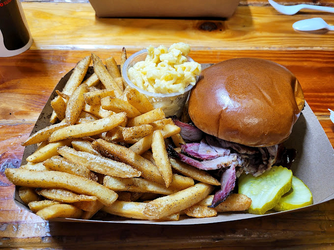 This isn't just a sandwich; it's a brisket revelation on a bun. The pickle slice isn't garnish—it's the perfect acidic counterpoint to smoky richness.