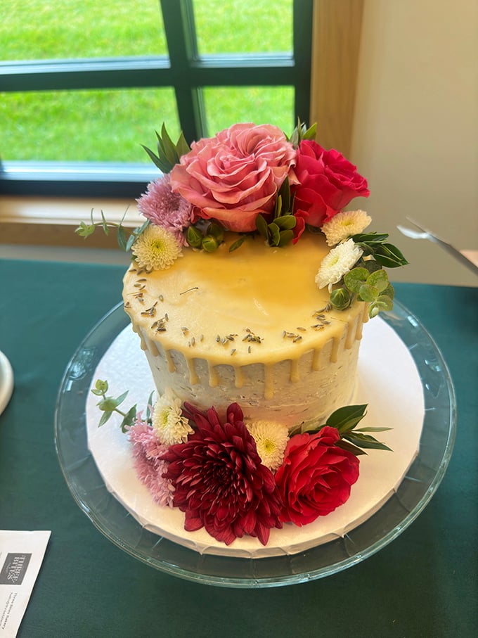 A celebration cake adorned with fresh flowers that says, "I care enough to bring something that tastes as good as it looks."