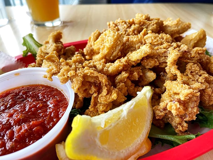 Crispy calamari that shatters like dreams when you bite into it. The marinara sauce stands ready for its supporting role in this seafood drama.