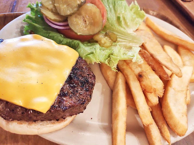 Cheeseburger architecture at its finest – the melty cheese cascading down the sides like a yellow waterfall of happiness.