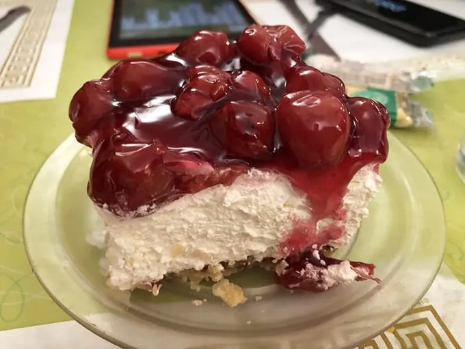 Cheesecake slice so generous it could feed a small family, or one very determined dessert enthusiast.
