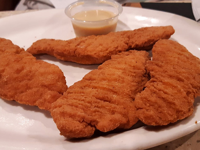 Chicken fingers that actually taste like chicken—a crispy, golden reminder that simple food done right is culinary poetry.