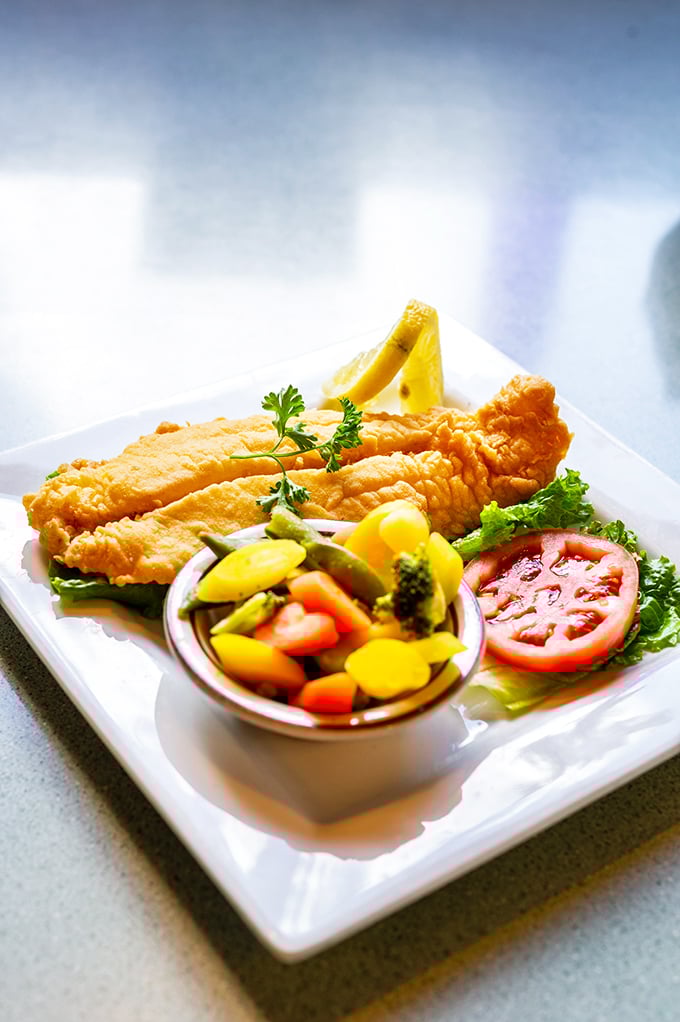 Golden-fried fish that would make Neptune himself abandon the sea. The colorful vegetable medley provides the illusion of healthfulness we all need.