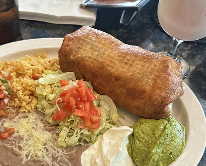 
Behold the chimichanga in all its golden-fried glory! This crispy vessel of deliciousness is what dreams—and stretchy pants—were made for.