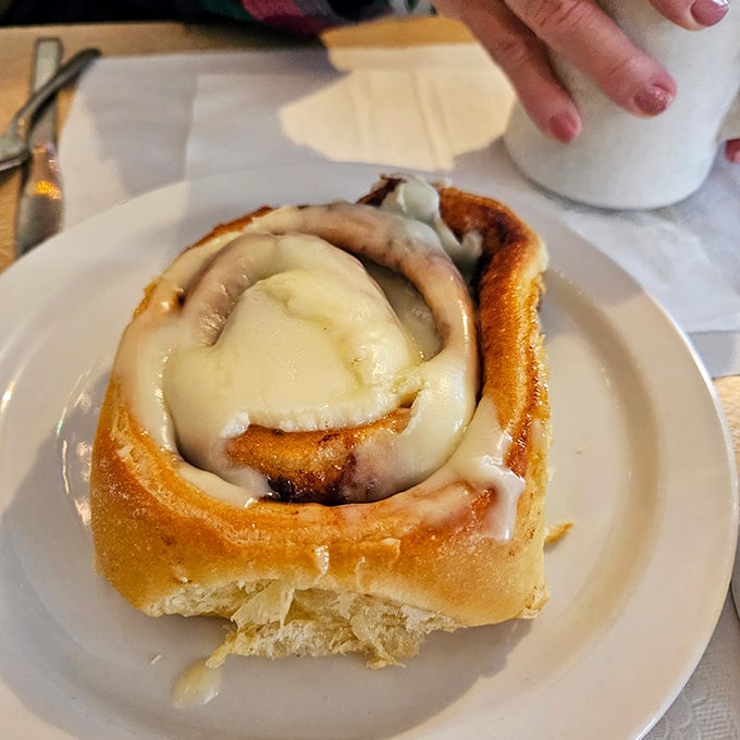 This cinnamon roll isn't just breakfast, it's an event. The icing melts into every warm, cinnamon-spiced crevice like it was destined to be there.