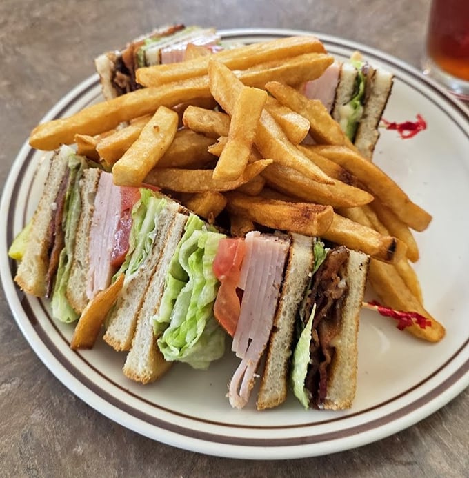 The club sandwich—three stories of deliciousness with fries as the perfect neighbors. No avocado toast in sight!