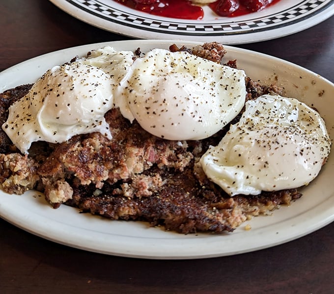 Corned beef hash crowned with poached eggs – a breakfast that says "you won't need lunch today" in the most delicious way possible.