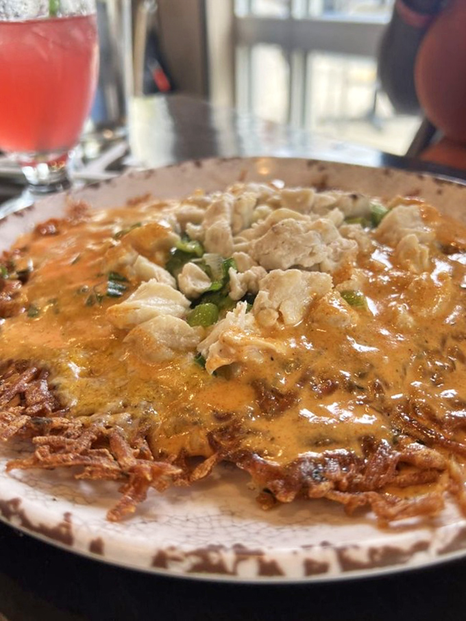 This crab hash is what breakfast dreams are made of—crispy potatoes, tender crab, and green onions swimming in a sauce worth bottling and selling.