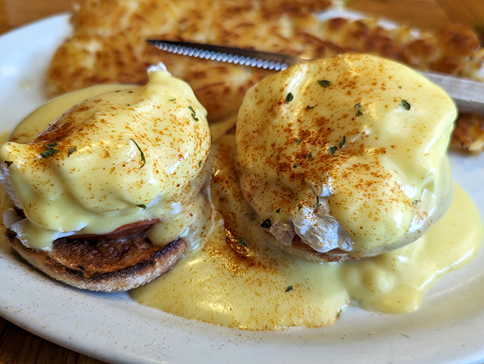 Eggs Benedict lounging in hollandaise like they're at a spa day, but tastier.