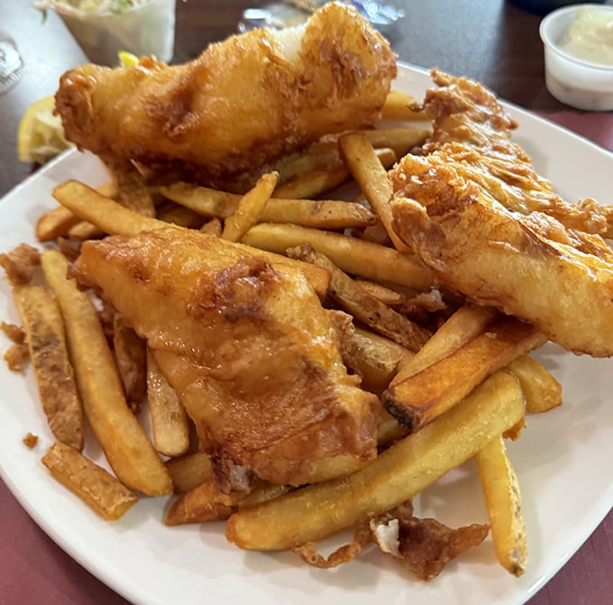 Fish and chips that would make a British pub-goer weep with joy. These golden planks of cod aren't just fried—they're transformed.