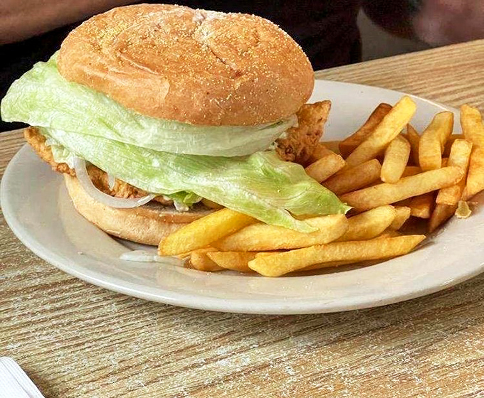 A fish sandwich that doesn't need to name-drop its pedigree – the proof is in that perfectly golden fillet peeking out beneath fresh lettuce.