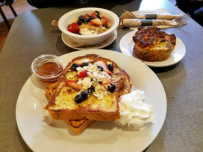 French toast that looks like it graduated from breakfast academy with honors – those berries and whipped cream aren't just toppings, they're the crown jewels.