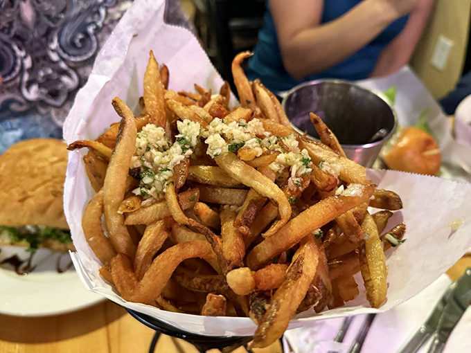 French fries wearing their Sunday best. These golden beauties dressed in garlic and herbs prove that sometimes the supporting actors steal the show.