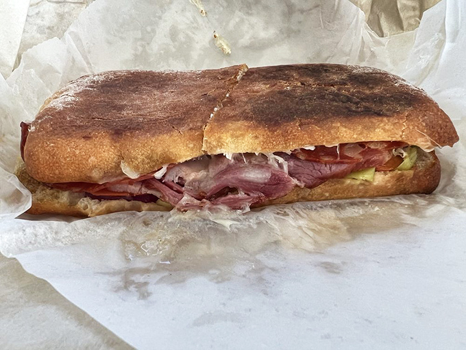 This isn't just a sandwich—it's an engineering marvel of crusty bread, savory meats, and fresh vegetables that demands both hands and your full attention.