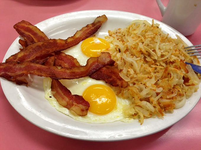 Two sunny eggs with bacon and hash browns—the breakfast equivalent of a perfect day where everything goes right from the moment you wake up.