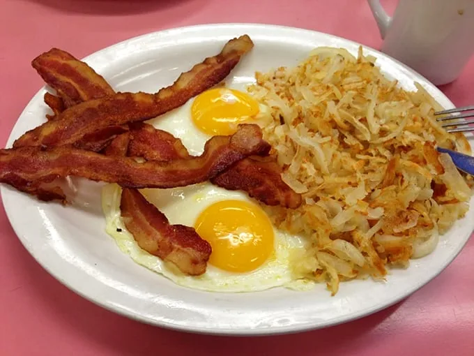 Two sunny eggs with bacon and hash browns—the breakfast equivalent of a perfect day where everything goes right from the moment you wake up.
