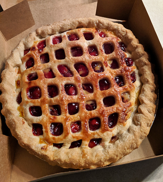 This cherry pie's lattice work is so perfect it makes you wonder if the baker moonlights as a geometry professor.