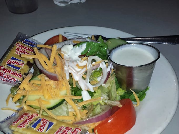 The humble house salad, elevated to art form with fresh ingredients and that cup of homemade dressing waiting patiently.