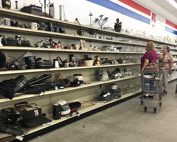 Housewares heaven stretches along well-stocked shelves. Two shoppers contemplate which kitchen treasures might deserve a second life in their homes.