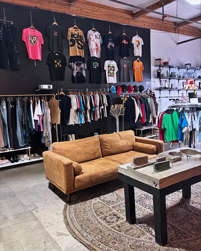 This cozy lounge area invites shoppers to take a breather, surrounded by carefully displayed vintage tees that tell stories of concerts past.