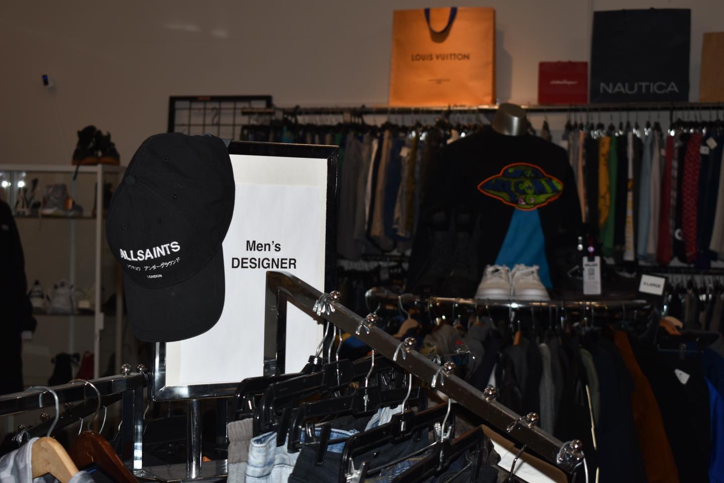 Designer dreams come true in the men's section. That All Saints cap and Louis Vuitton shopping bag aren't just decorations—they're previews of possible finds.
