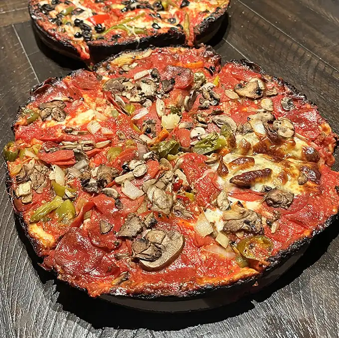 The legendary caramelized crust of a pan pizza—where cheese meets hot pan and creates that blackened edge that's worth fighting your tablemates for.
