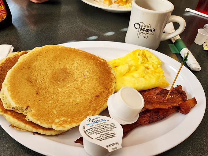 The pancake-bacon-egg trinity that proves breakfast is the most important relationship of the day. That golden flapjack is practically winking at you.