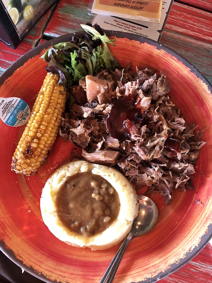 Pulled pork that doesn't need fancy presentation—just a heap of smoky goodness with beans and corn that make you question why you ever eat anything else.