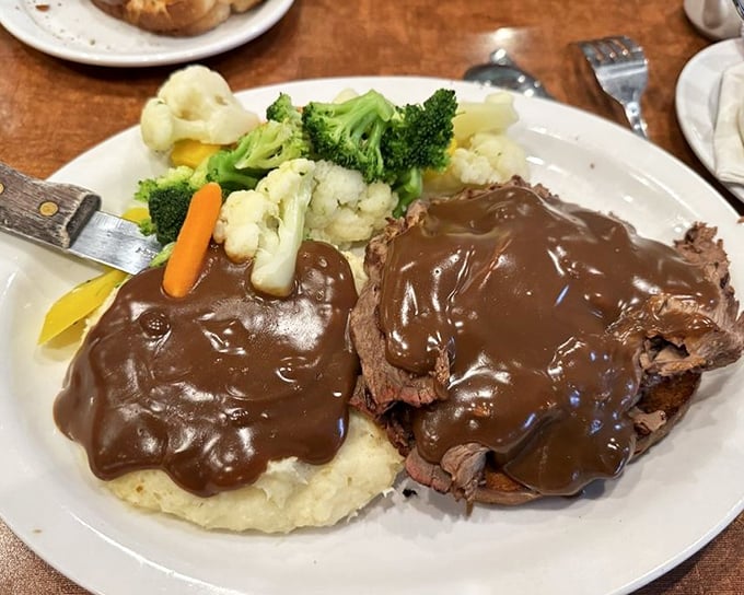 This isn't just roast beef—it's a monument to slow-cooking, served with vegetables that actually taste like vegetables should.