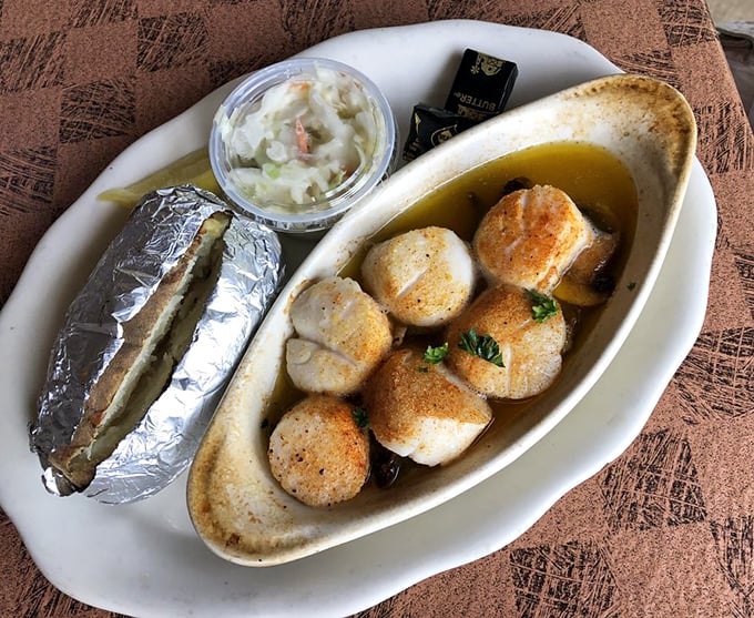 Scallops bathed in butter that glisten like culinary jewels. These aren't just seafood—they're ocean candy for grown-ups.