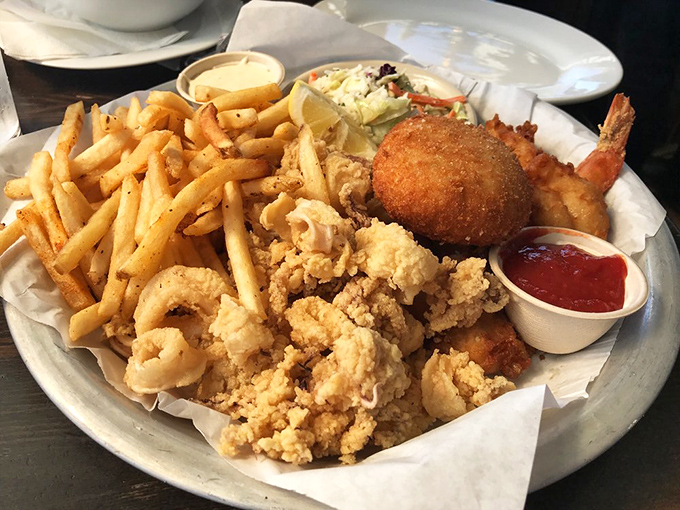 This seafood platter doesn't just feed you – it throws a maritime celebration complete with crispy calamari and fresh fries.