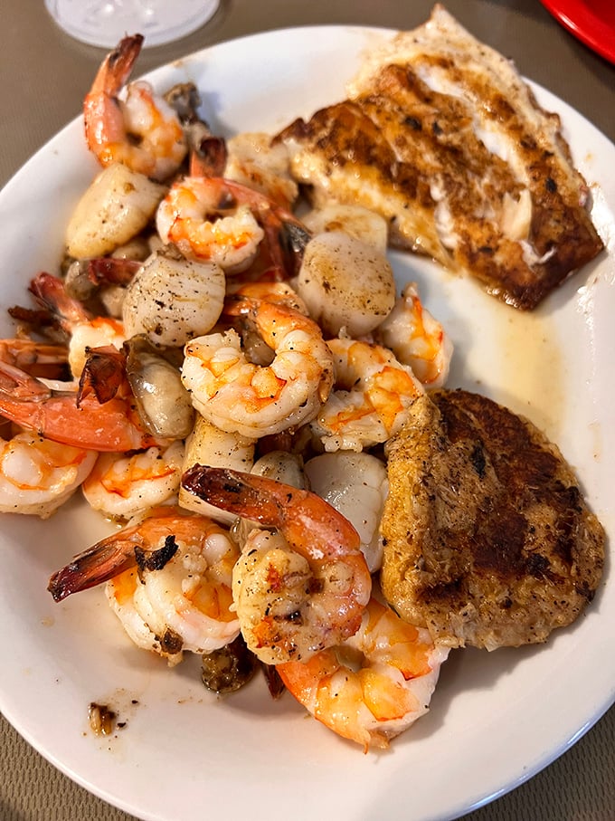 The seafood trifecta – plump shrimp, delicate scallops, and that crab cake again, proving that sometimes the best things come on plain white plates.