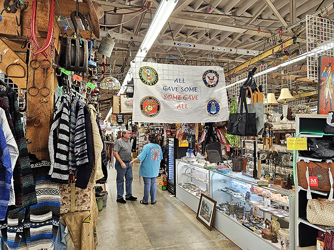 Beneath a banner honoring military service, shoppers engage in the time-honored tradition of "just looking," which inevitably leads to "just buying."
