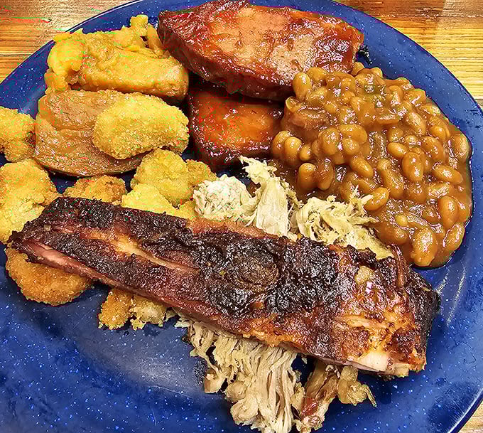 This isn't just a meal; it's edible architecture – layers of smoky ribs, pulled meat, and sides stacked like a delicious Southern skyscraper.