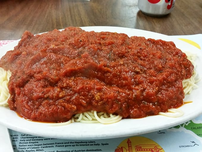 Spaghetti that would make your Italian grandmother weep with joy, buried under a red sauce avalanche of tomato perfection.
