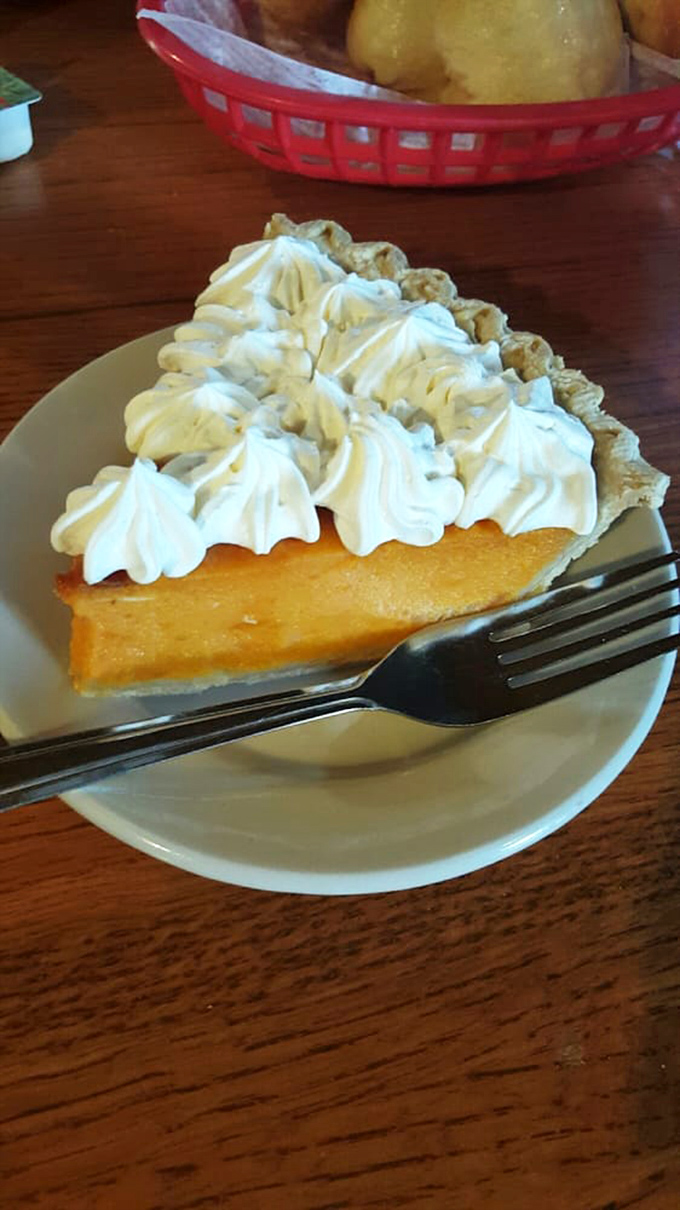 Sweet potato pie crowned with clouds of whipped cream—proof that vegetables can indeed be the star of dessert.