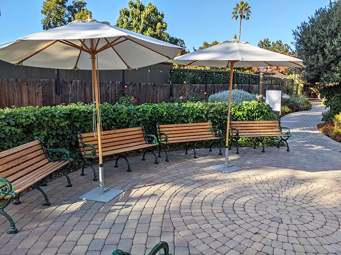 These peaceful garden benches invite weary visitors to rest their legs after navigating the mansion's many staircases to nowhere.