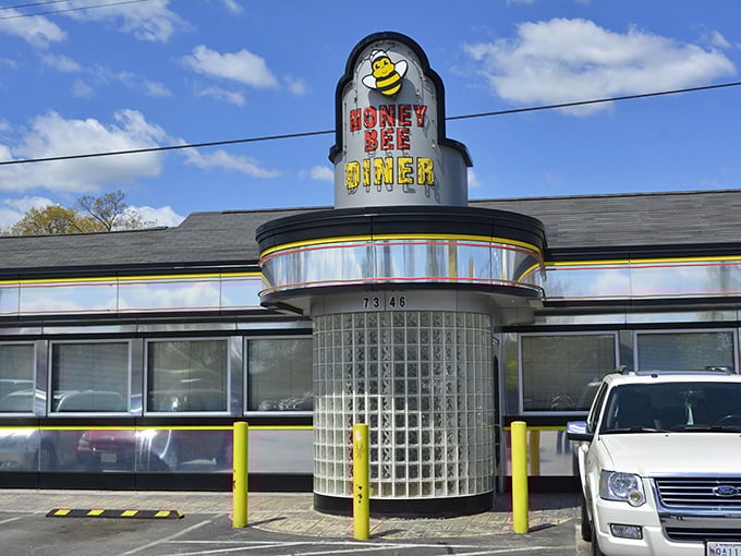 Honey Bee Diner (exterior): "The cheerful bee beckons breakfast lovers! Inside, pancakes stack higher than your weekend to-do list."