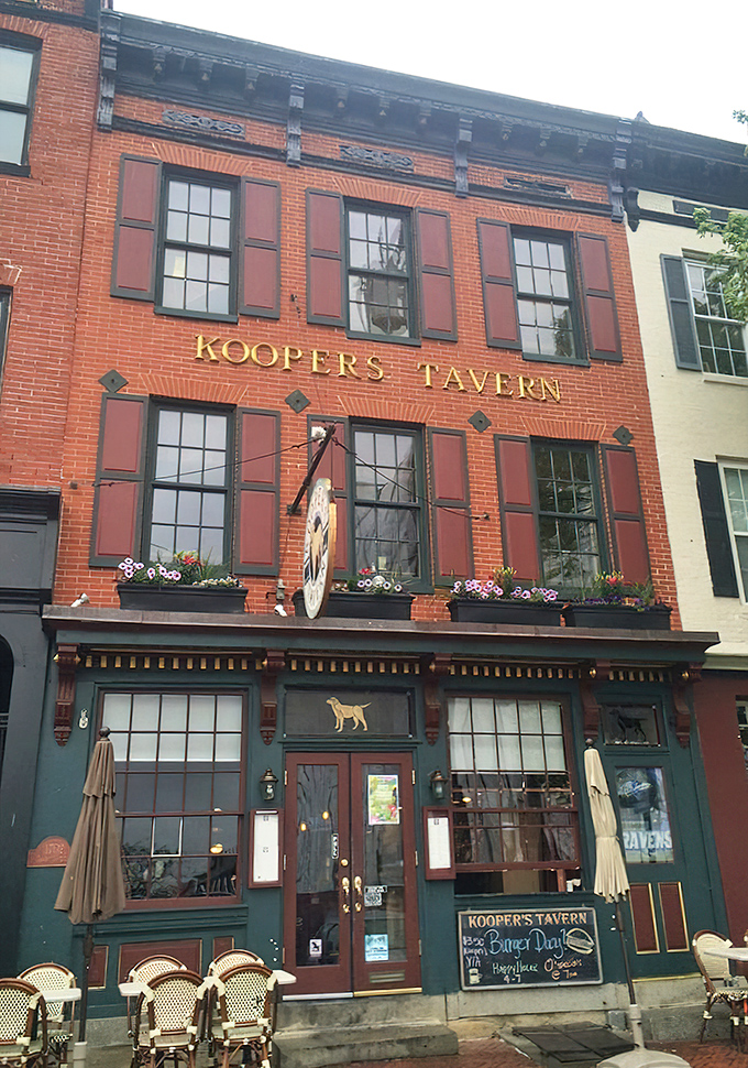 Kooper's Tavern's historic brick facade brings old-world charm to modern burger mastery. Like a delicious time capsule with outdoor seating!