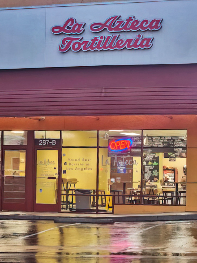 La Azteca Tortilleria's corner location might seem ordinary, but those windows conceal the magic of handmade tortillas and legendary burritos.
