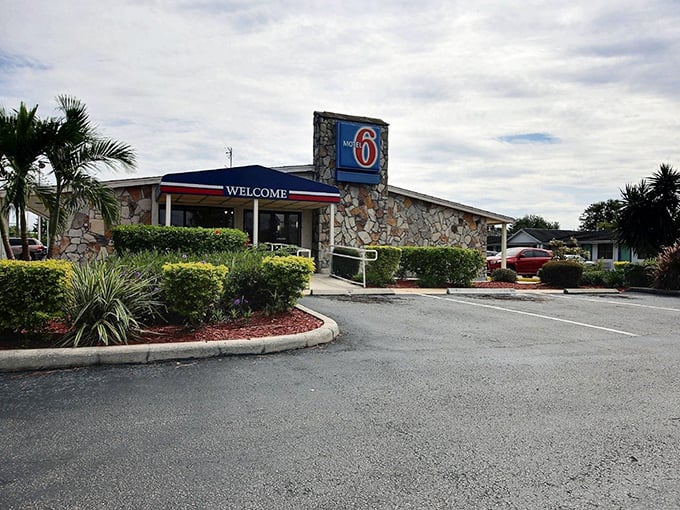 Palm Bay's Motel 6 welcomes road-weary travelers with stone-faced charm and tropical landscaping.