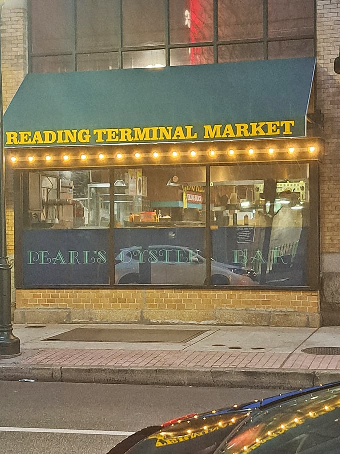 Pearl's Oyster Bar (night view): "Those glowing lights aren't just pretty—they're illuminating one of Reading Terminal Market's greatest treasures!"